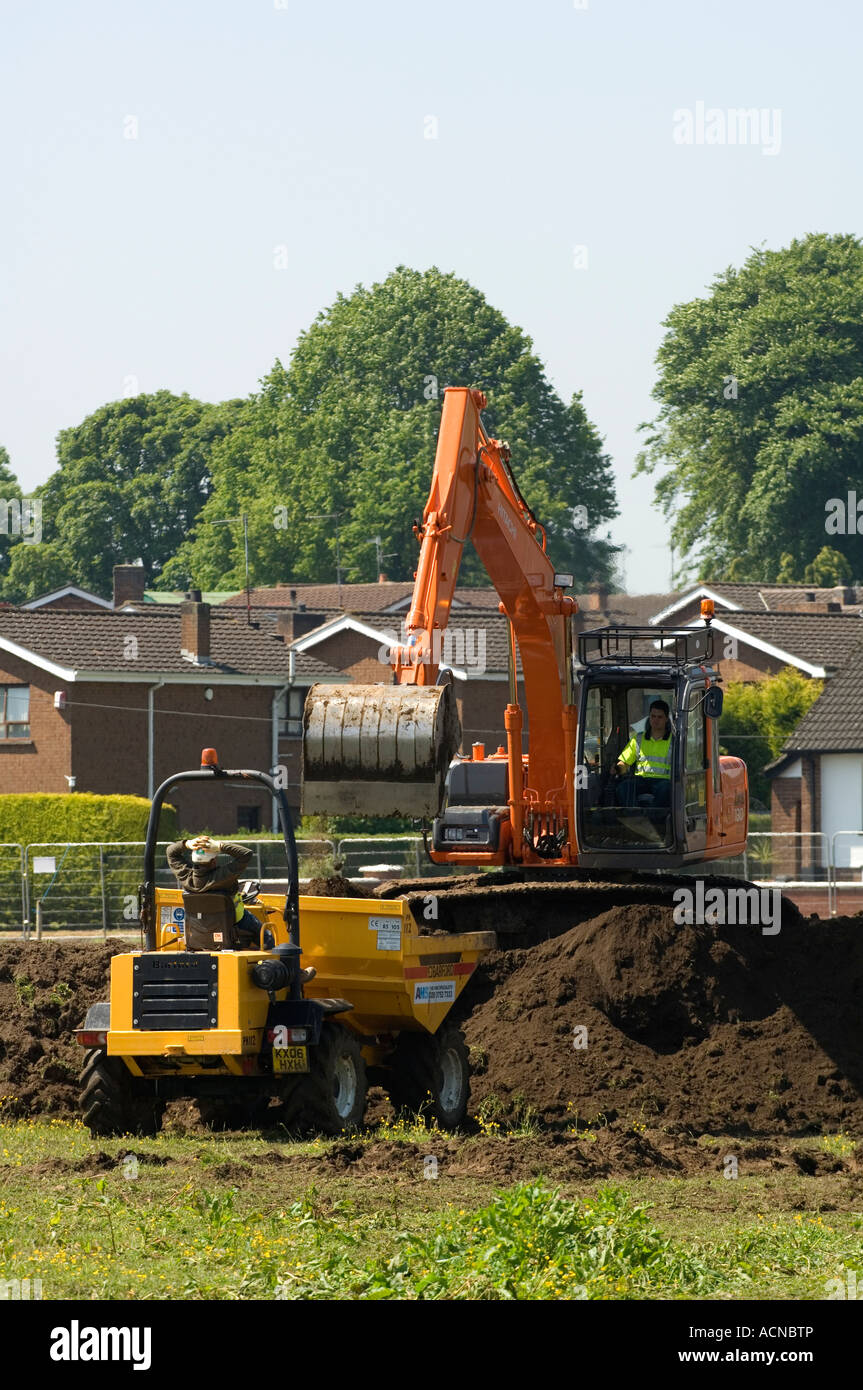 Dump trucks and digger Stock Photo - Alamy