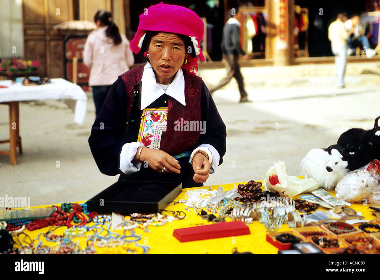 Tibetan lady and her small stall in the daily market at the town sq ...