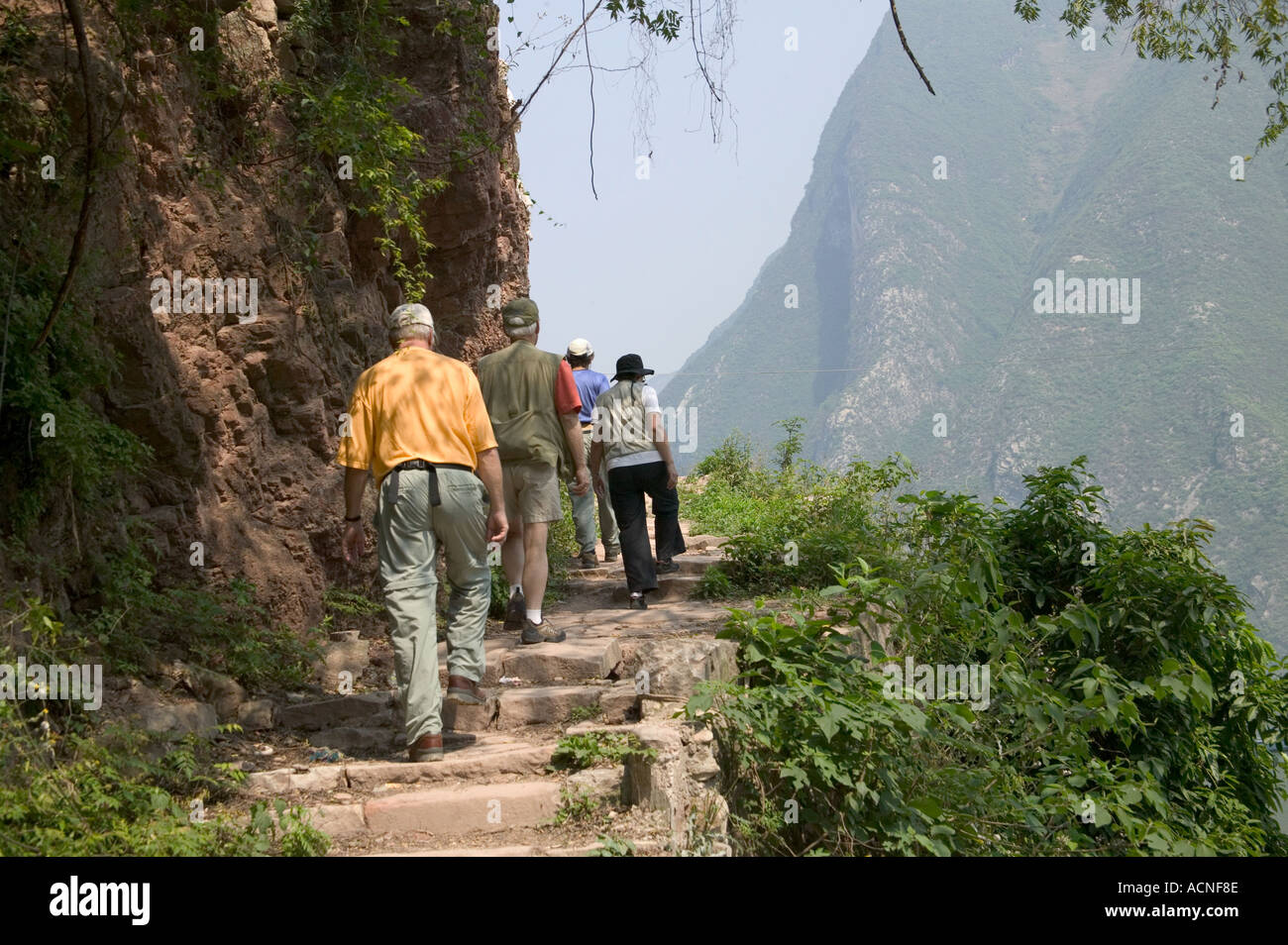 Western travelers hiking along ancient Trackers Path chiseled onto ...