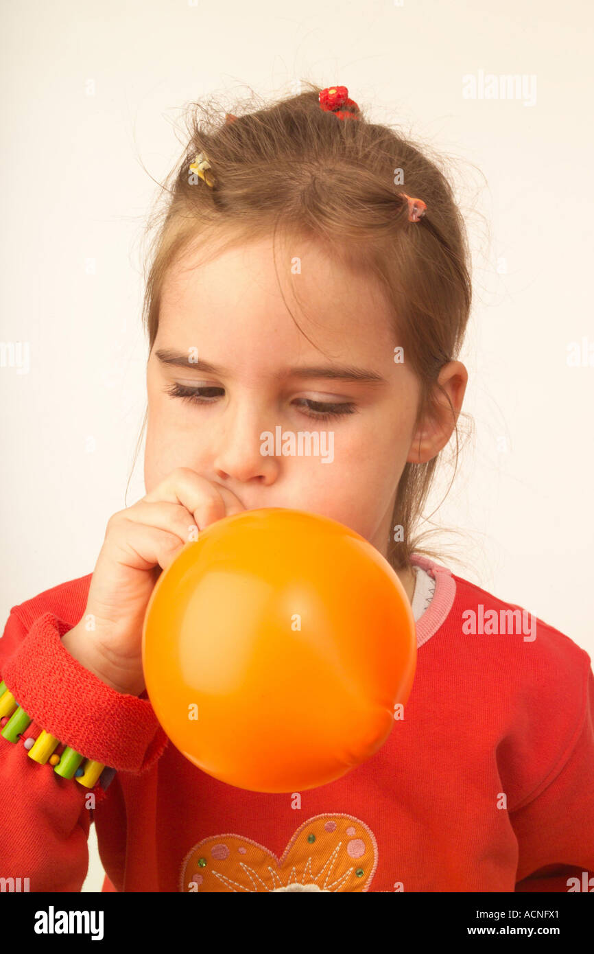 Girl inflating balloon hi-res stock photography and images - Alamy