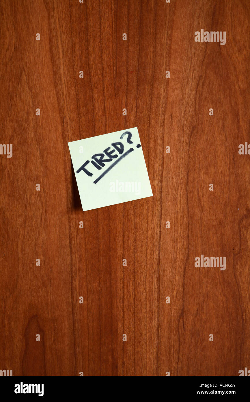 tired ? written on post it note memo Stock Photo - Alamy