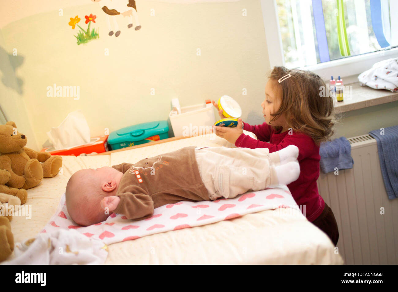 Little girl with baby Stock Photo - Alamy