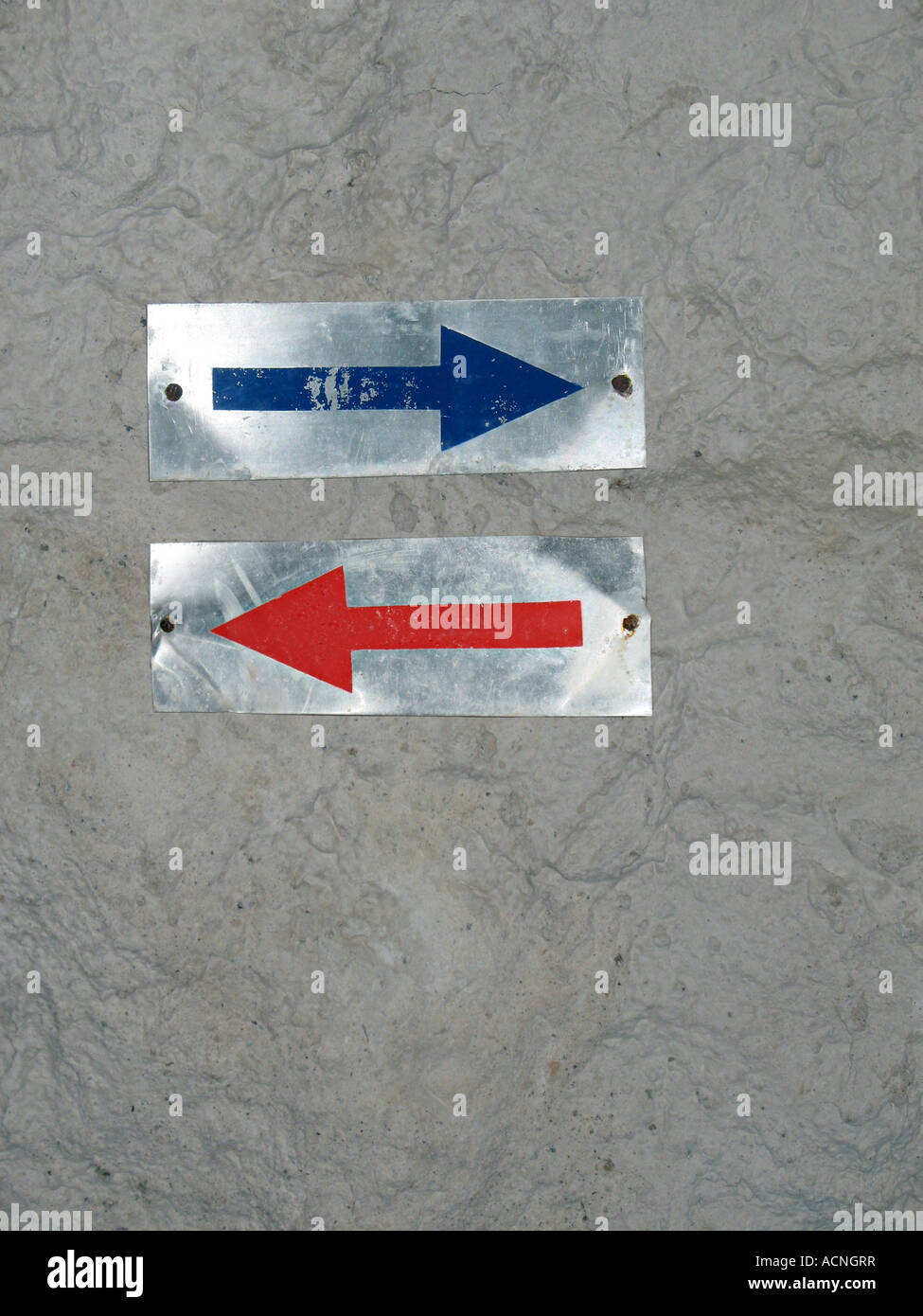 Two metallic arrow signs pointing in opposite directions Stock Photo ...