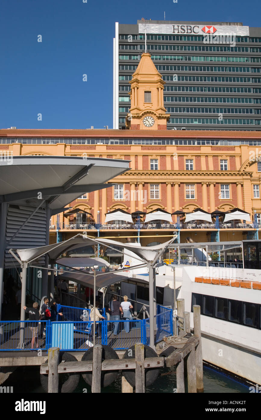 Ferry passengers on wharf by Ferry Building on waterfront on Waitemata ...