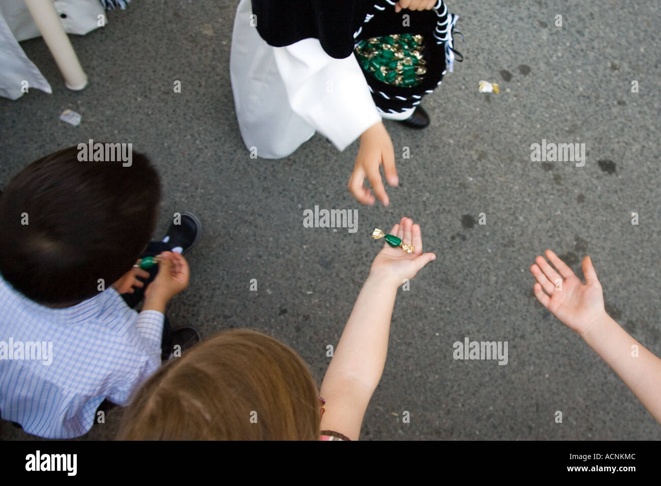 A penitent child giving candies to other children during an Easter ...