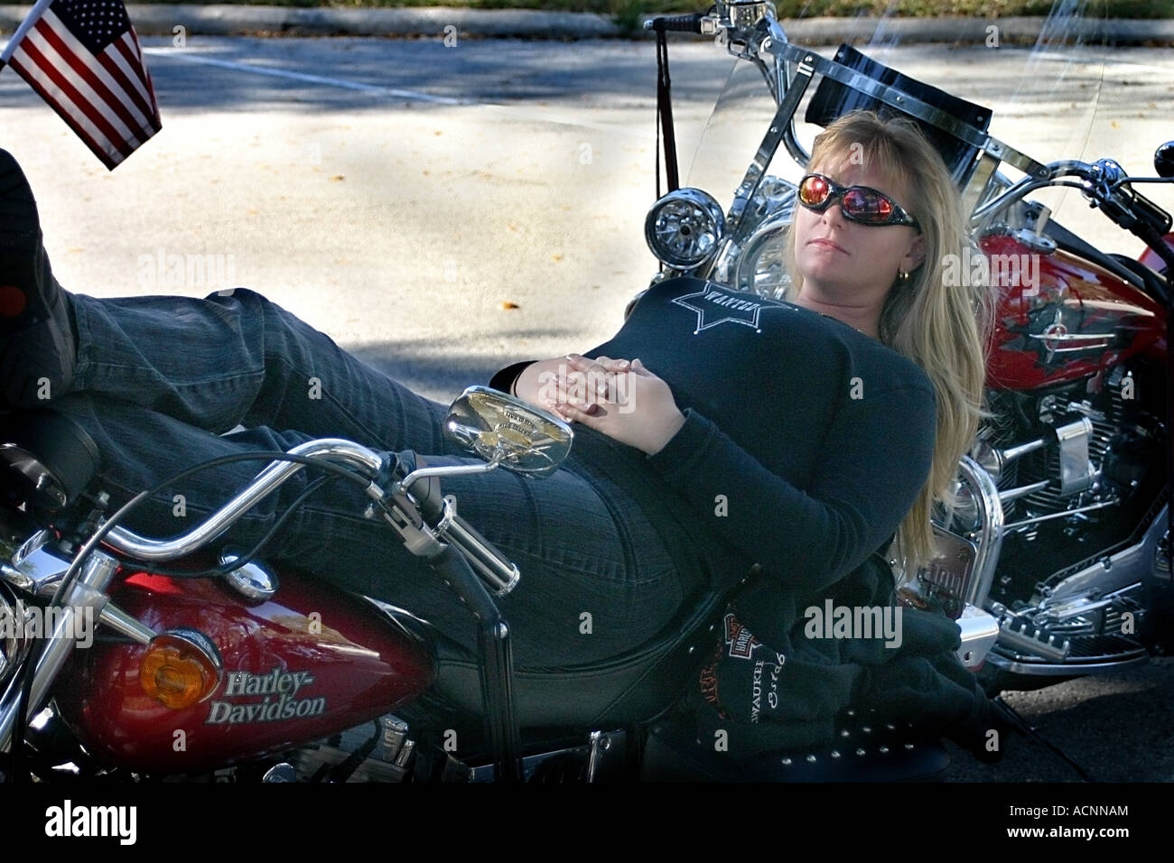 Woman Relaxing and Laying on a Motorcycle Stock Photo - Alamy