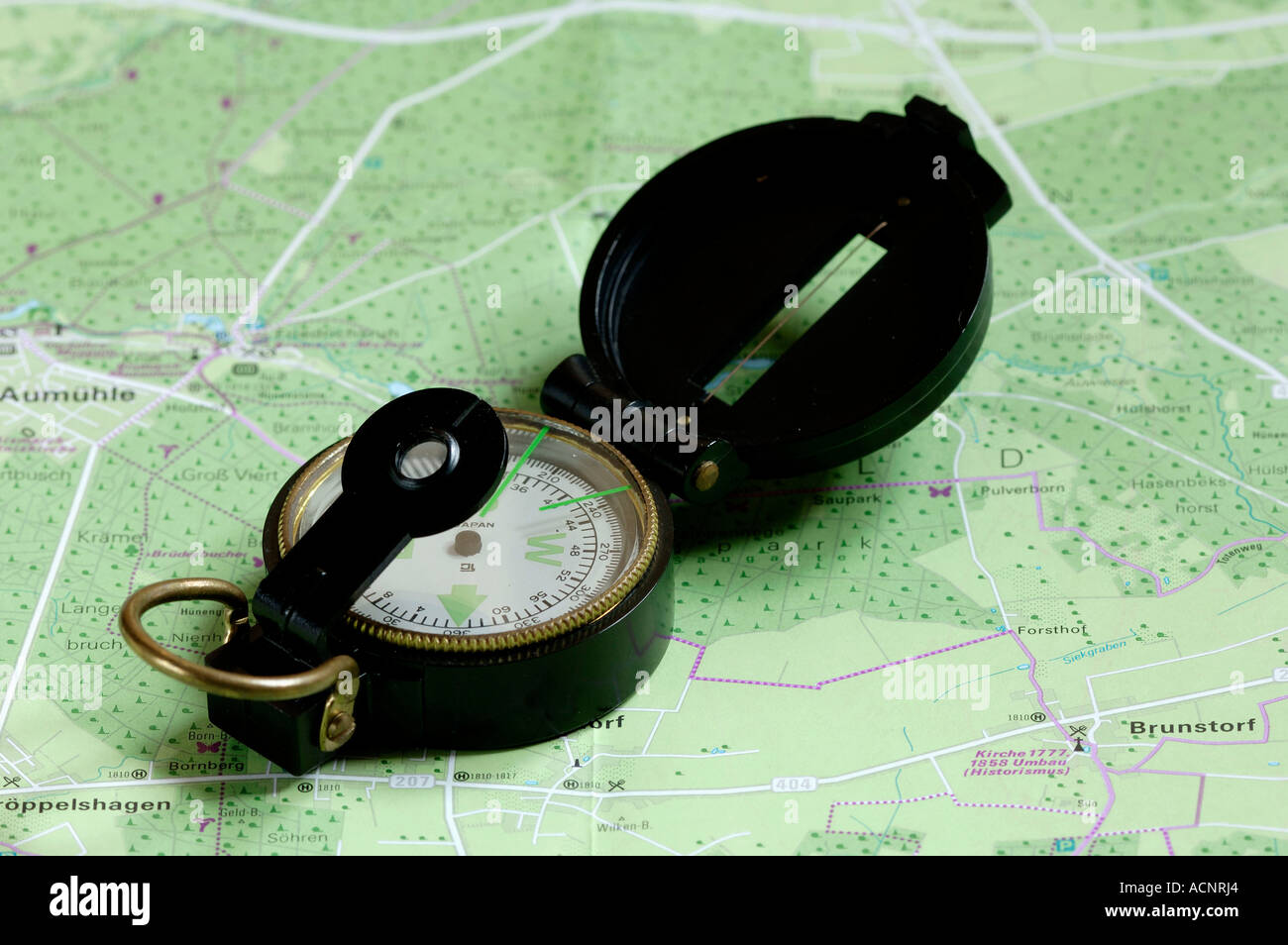 Compass and map Stock Photo - Alamy