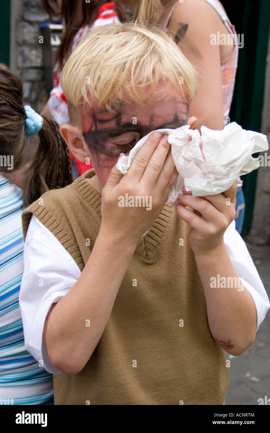 Front view boy wiping face painting off with a tissue Stock Photo - Alamy