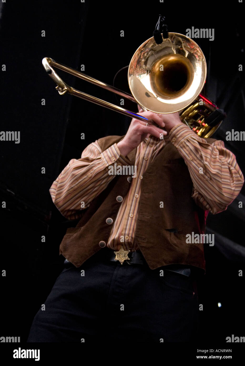 Front view of a trombone player wearing brown shirt and waistcoat Stock ...