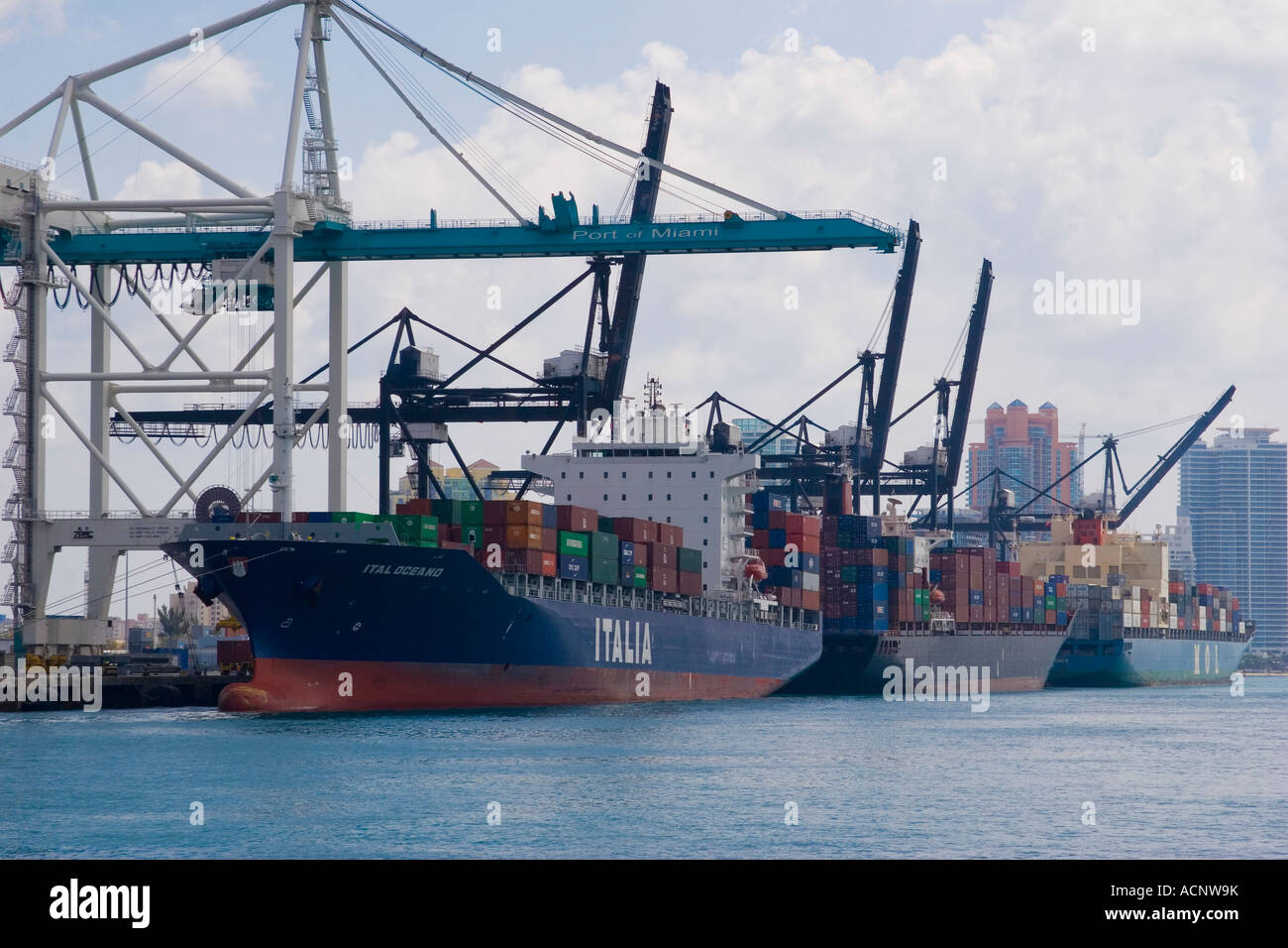 Container ship loaded with cargo docked at Port of Miami beside giant ...