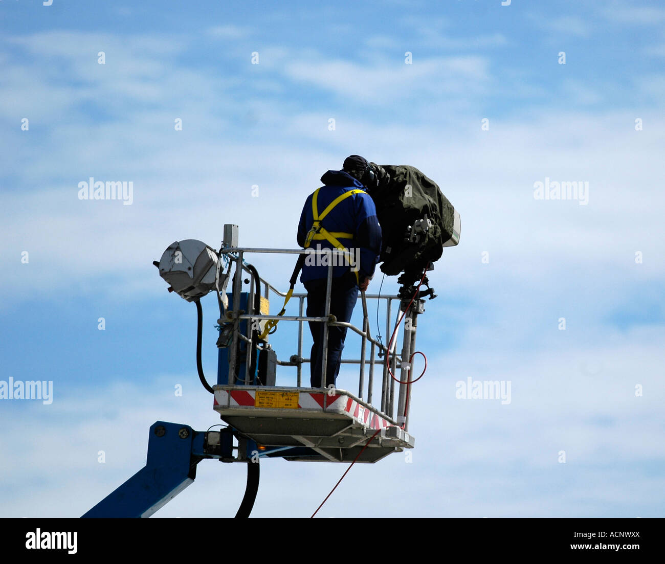 TV Cameraman filming from raised platform Stock Photo - Alamy