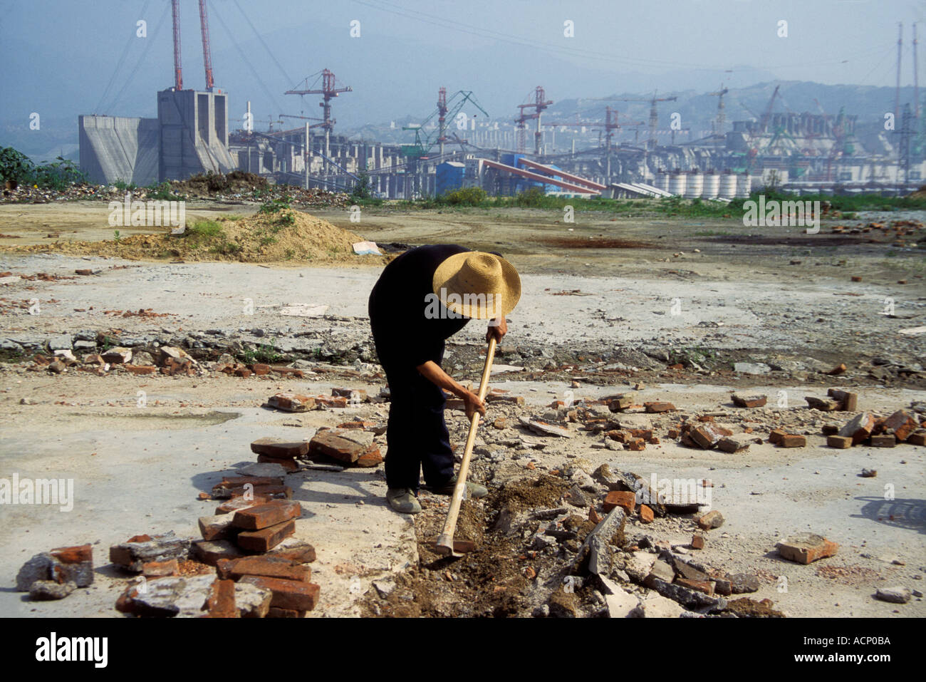 Farmer digging with hoe at construction site of Three Gorges Dam Hubei ...
