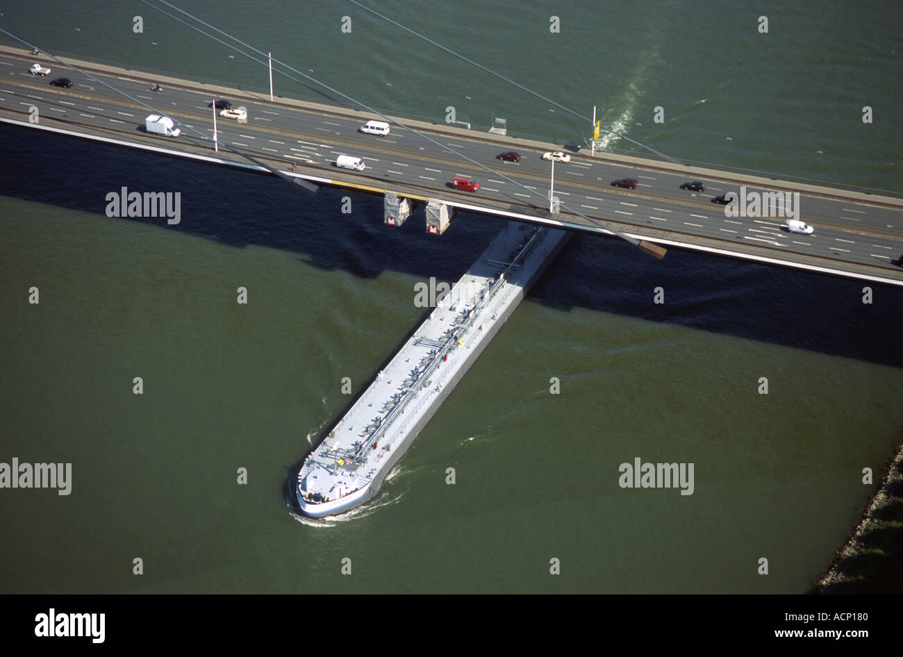 Ship transporting gas pass under a bridge in the city of Dusseldorf ...
