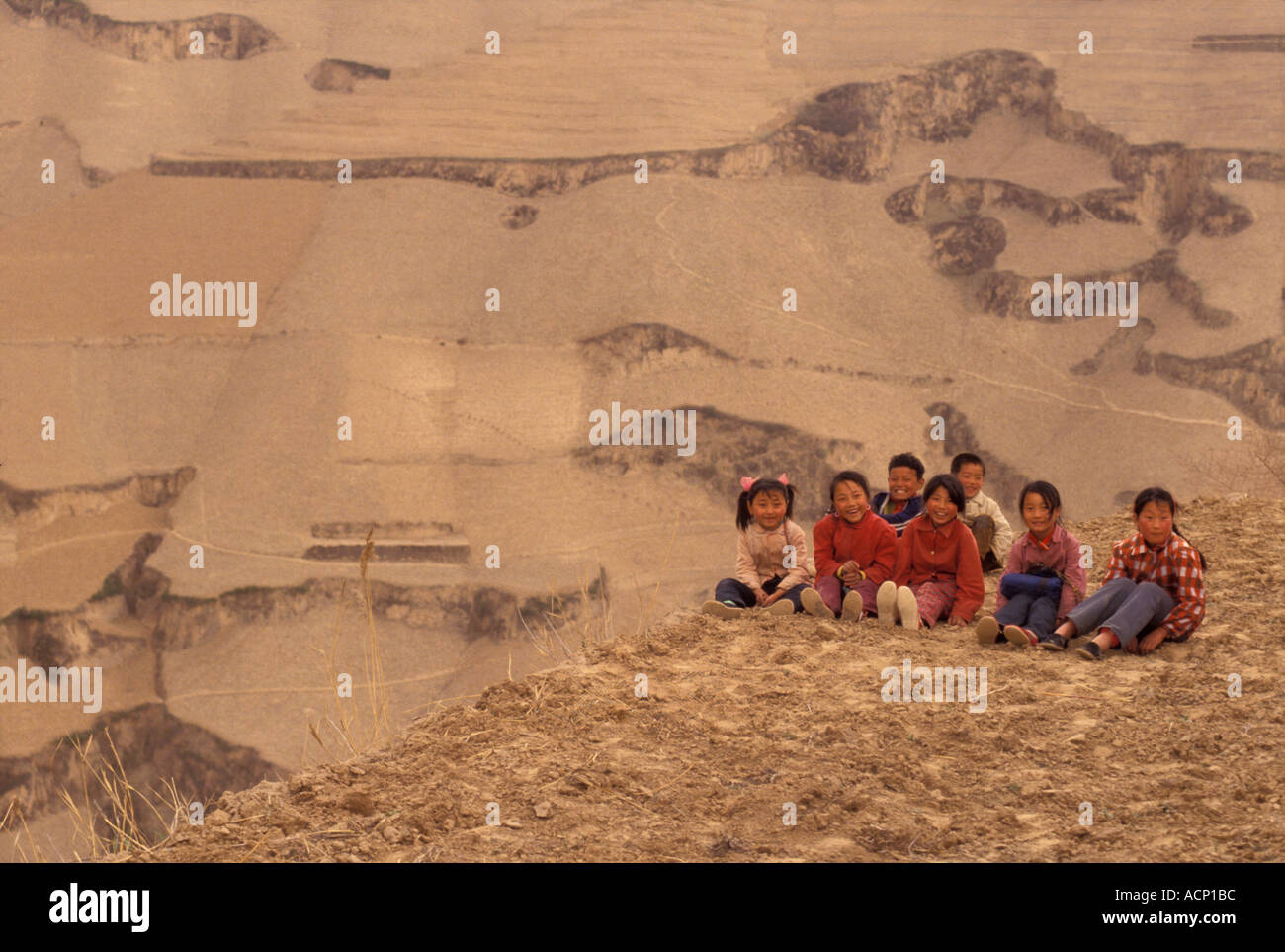 Children sitting on the Loess Plateau Yellow River Huang He area ...