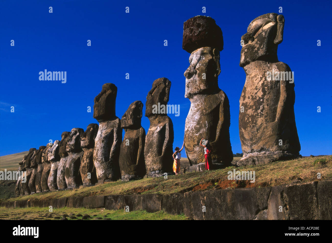 Polynesian girls with huge moais volcanic stone sculptures Ahu ...