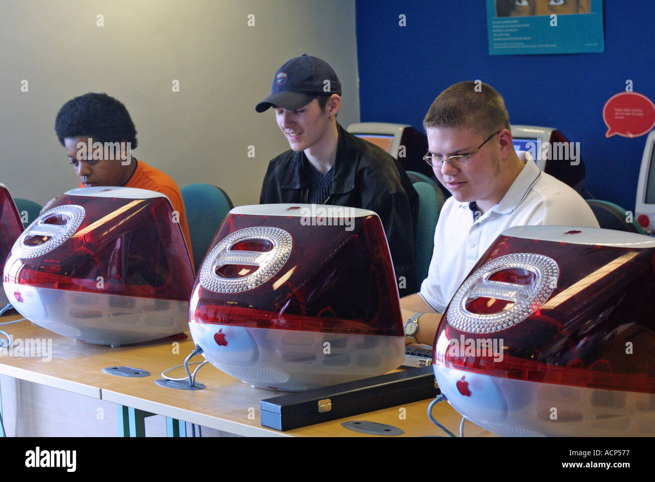 Three teenage male students working in computer suite hi-res stock ...