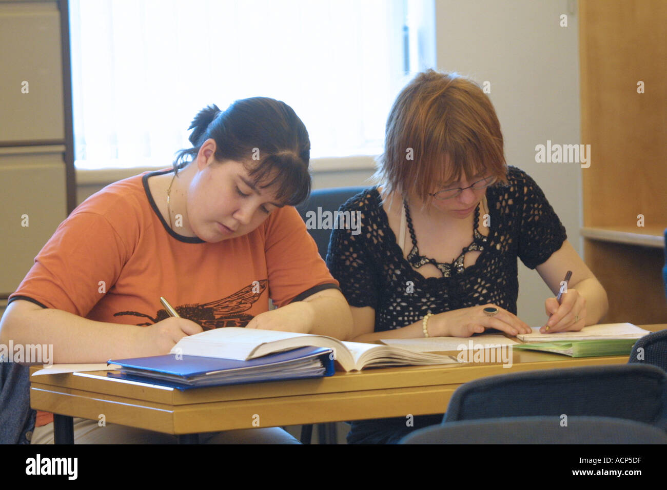 Female Students studying in library at Sixth form college South London ...