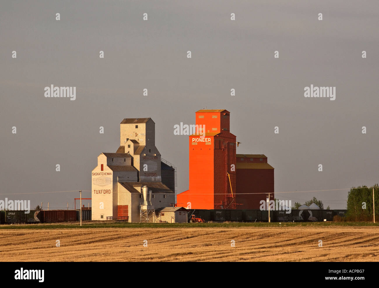 Setting sun lighting the Tuxford grain elevators in scenic Saskatchewan ...