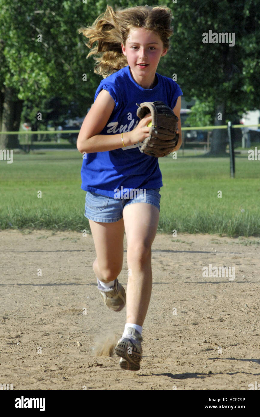 Young girl running towards the camera at a softball practice game Stock ...