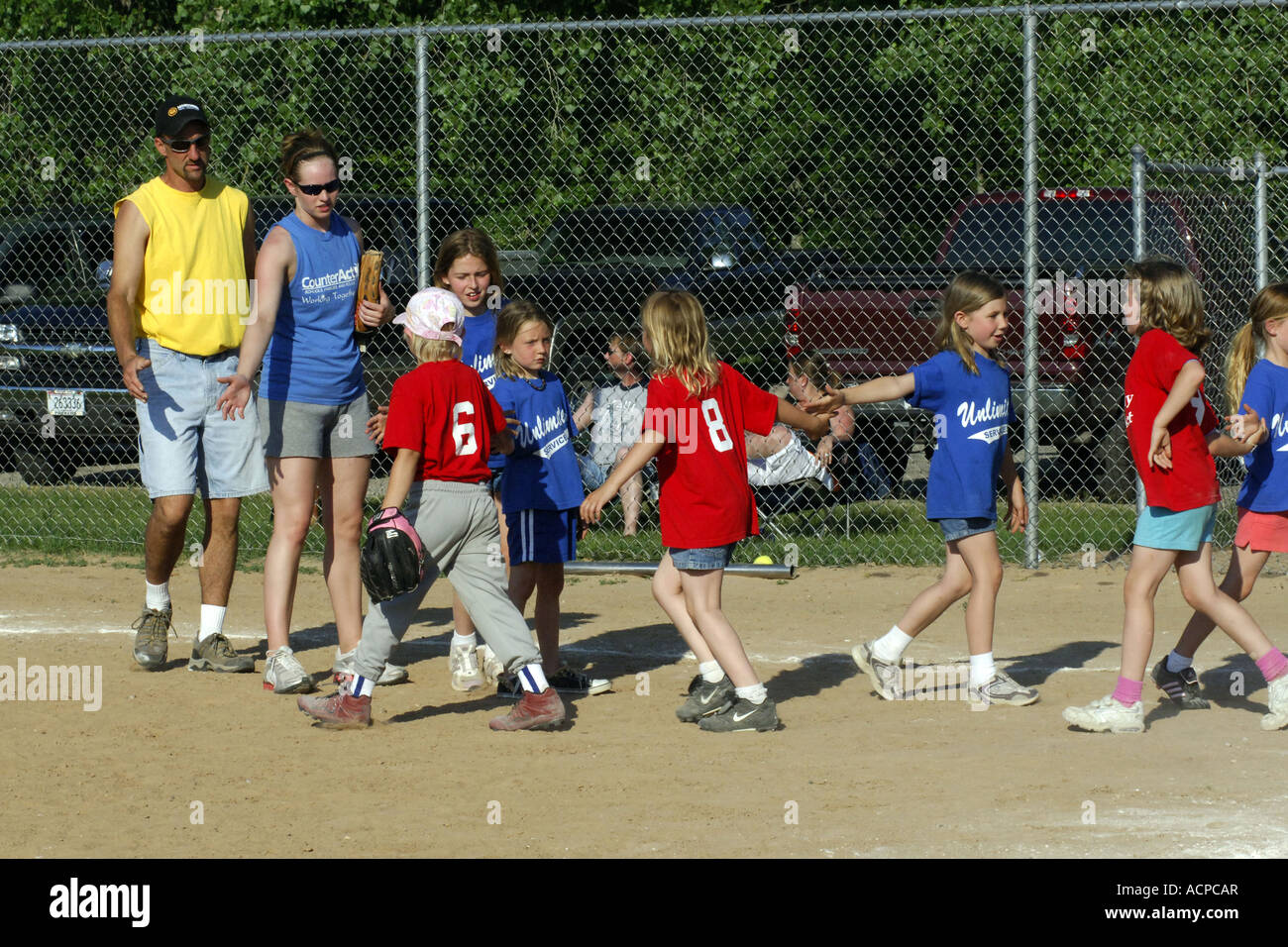 2nd grade school childrens finish softball practice with a low five ...