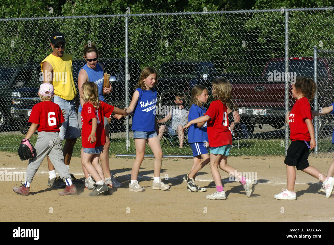 2nd grade school childrens finish softball practice with a low five ...