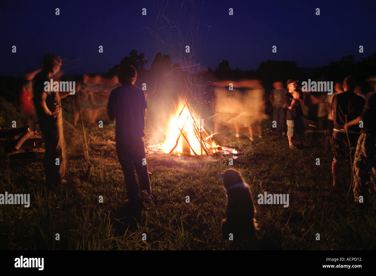 Teenagers Around Campfire Stock Photo - Alamy