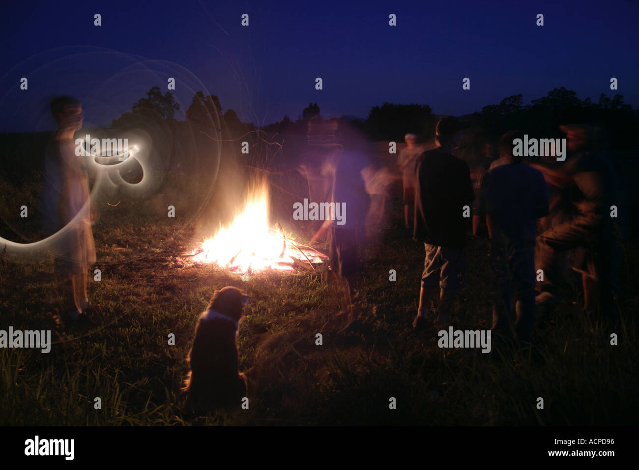 Teenagers Around Campfire Stock Photo - Alamy