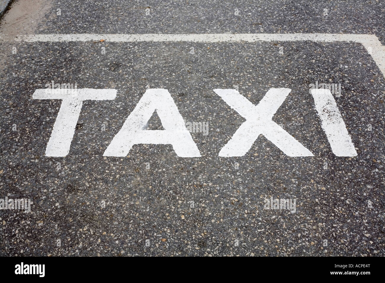 Taxi word painted on tarmac Stock Photo - Alamy