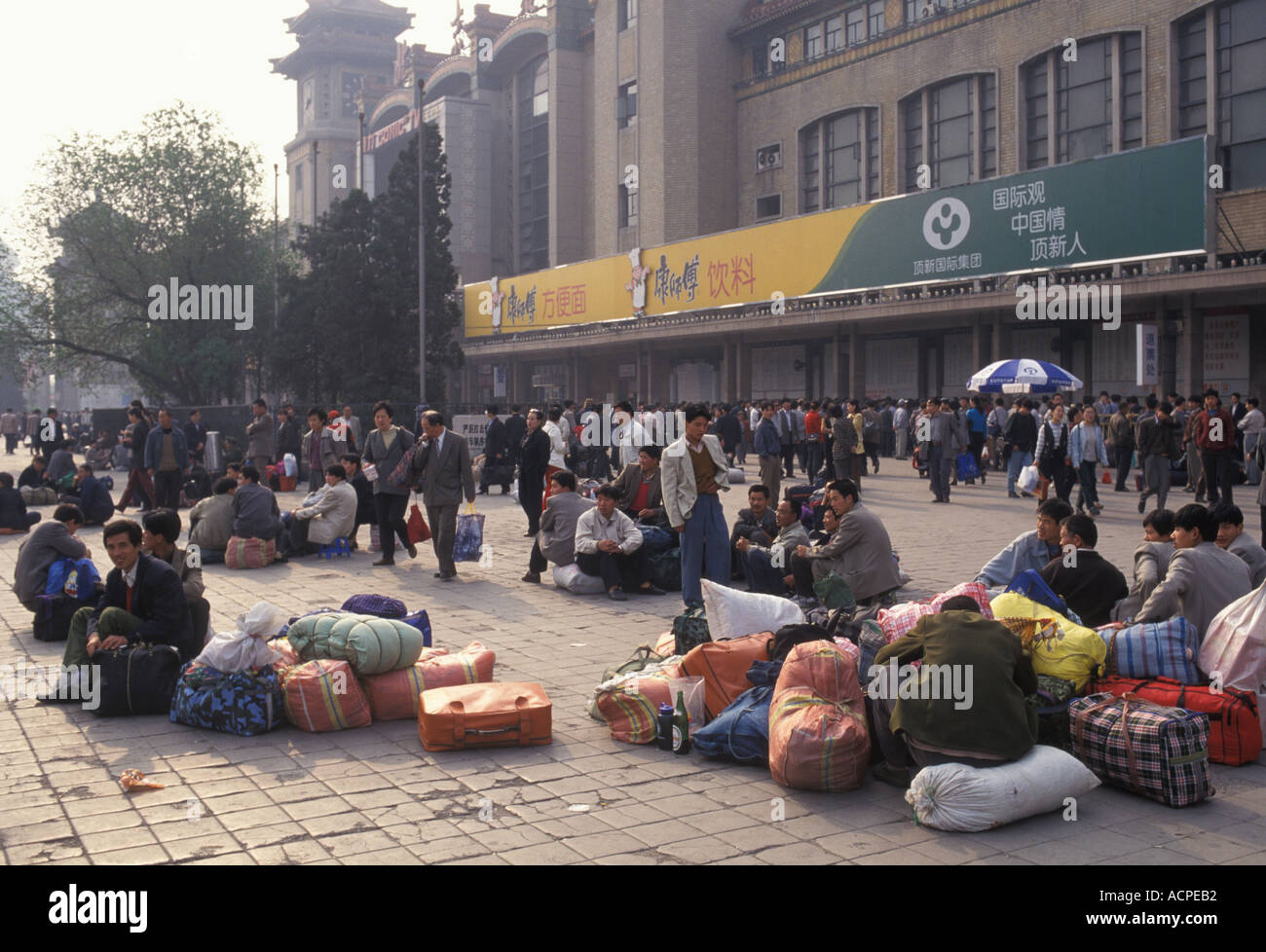 Beijing China 1990s. Migrant labour force workers wait for their trains ...