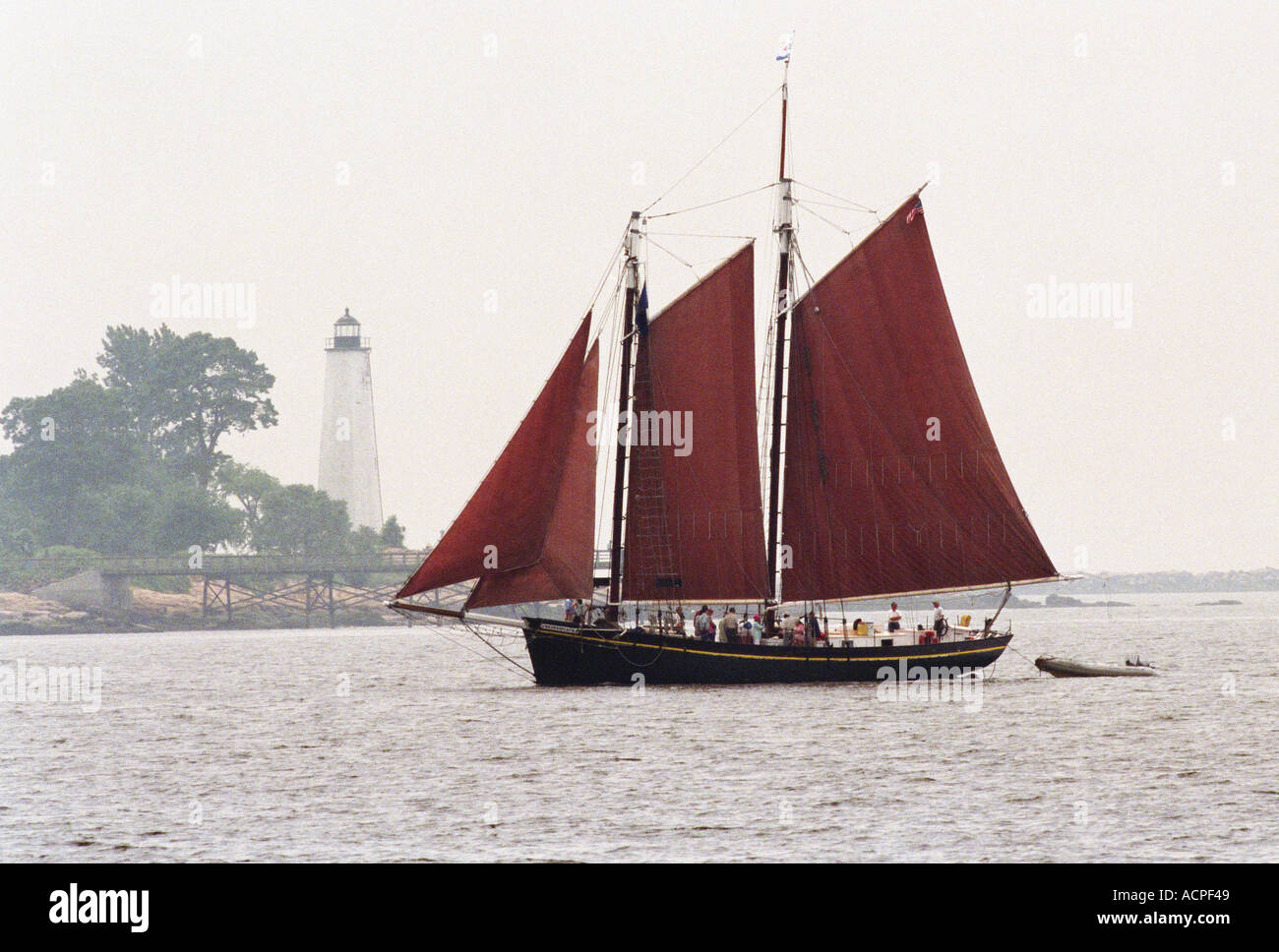 A schooner under full sail with lighthouse in distance New Haven ...