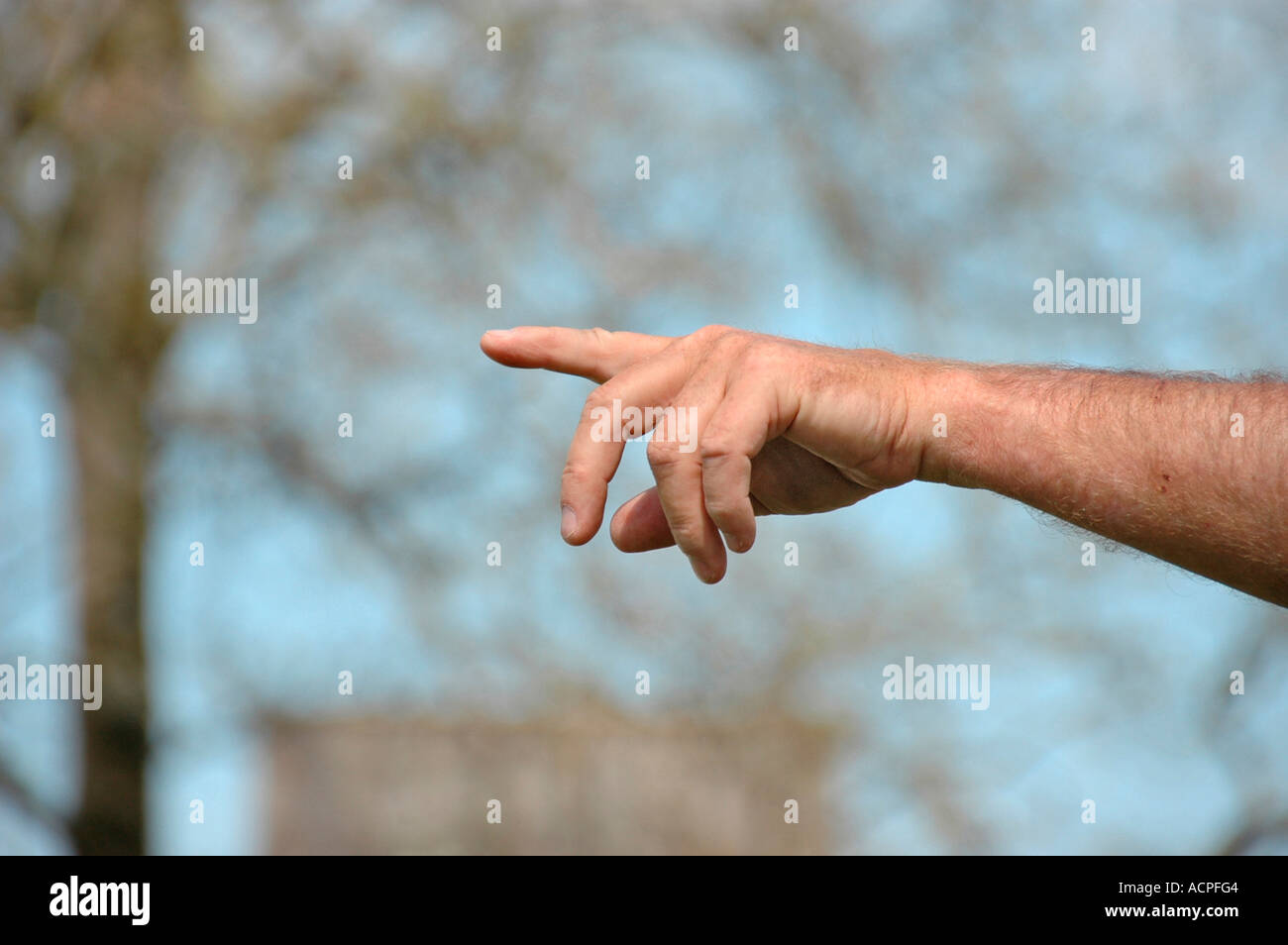 Pointing hand and fingers to the left direction of cowboy looking for ...