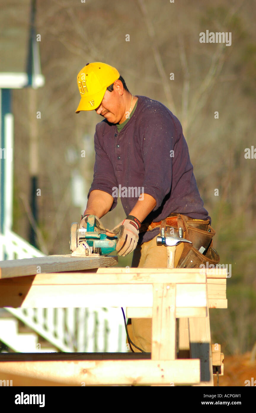 Hispanic Latin Mexican decking cutter on new home construction site ...