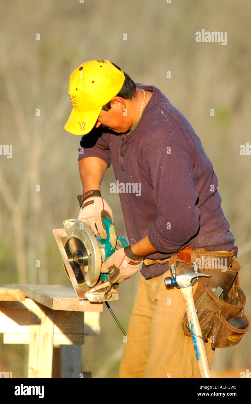 Hispanic Latin Mexican decking cutter on new home construction site ...