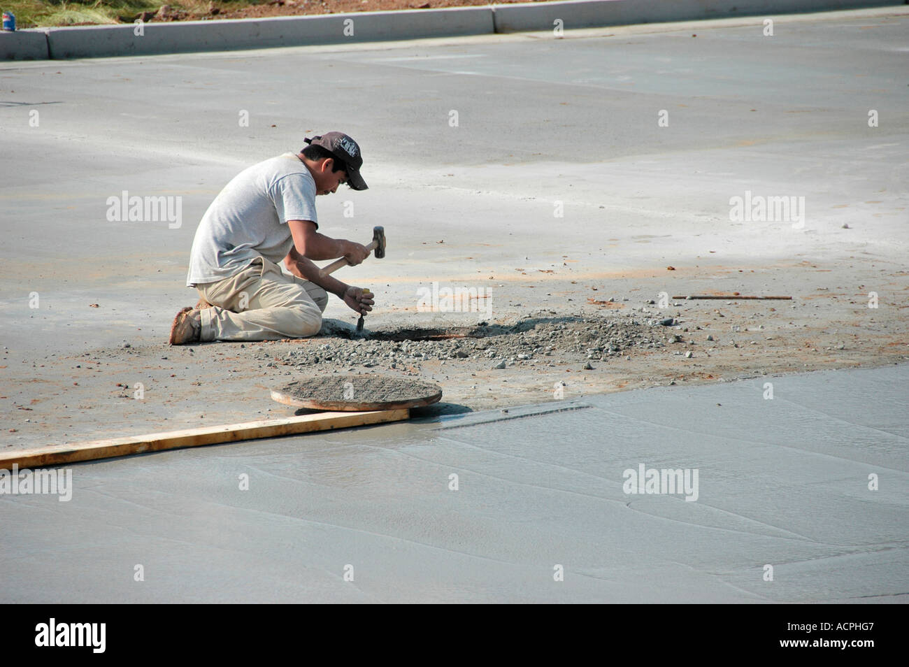 Pouring fresh cement from truck at real commercial business site being ...
