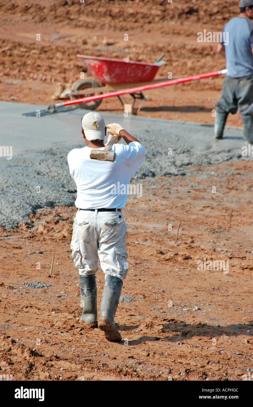 Pouring fresh cement from truck at real commercial business site being ...