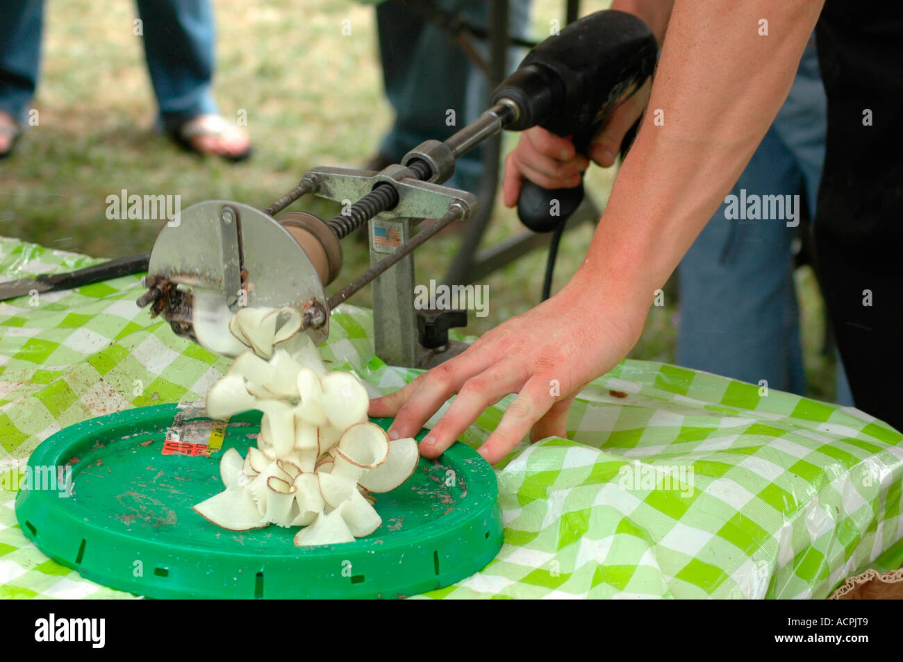 Making curly fries for sale from potatoes by hand on antique working ...