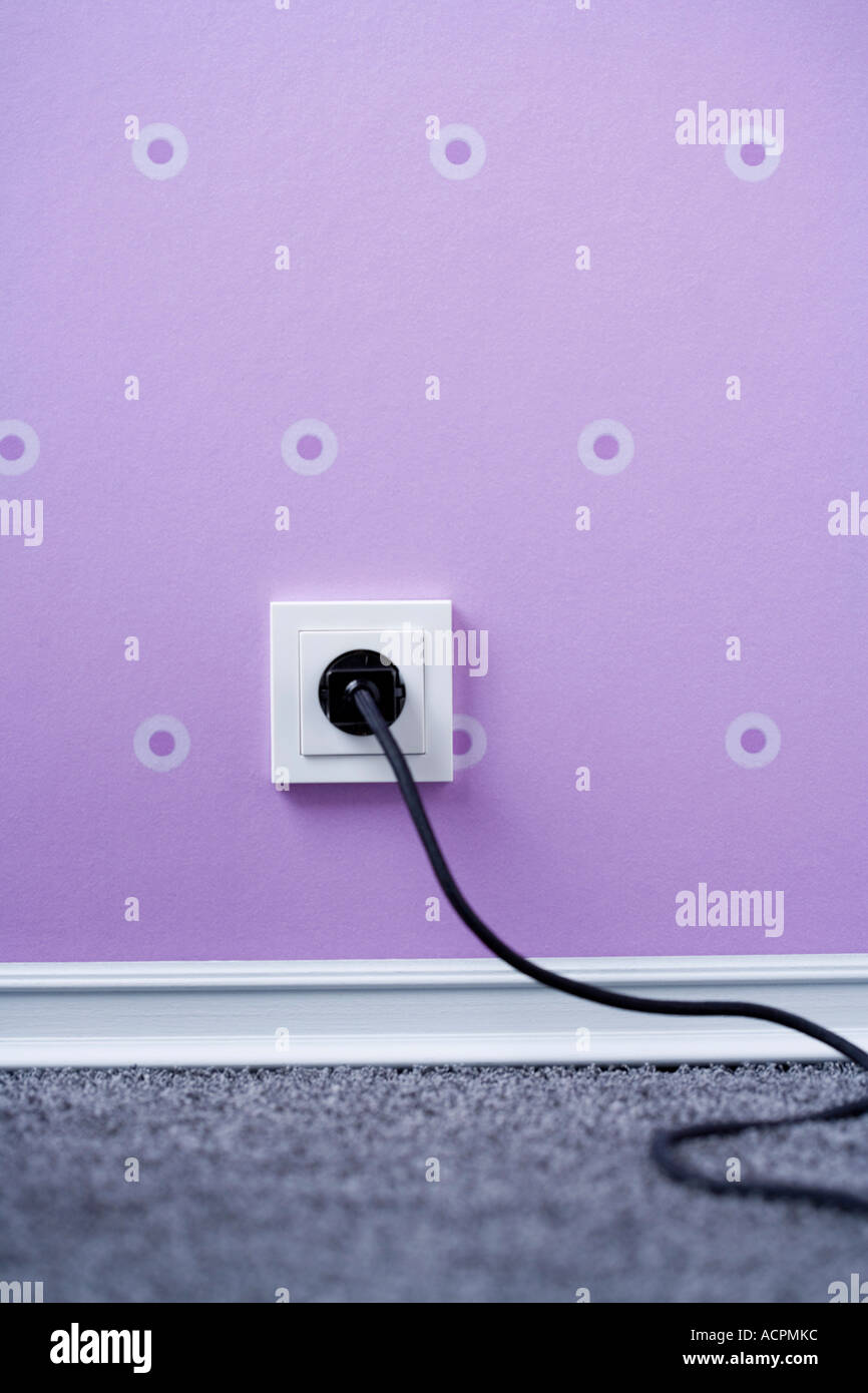 Electric plug in outlet Stock Photo - Alamy