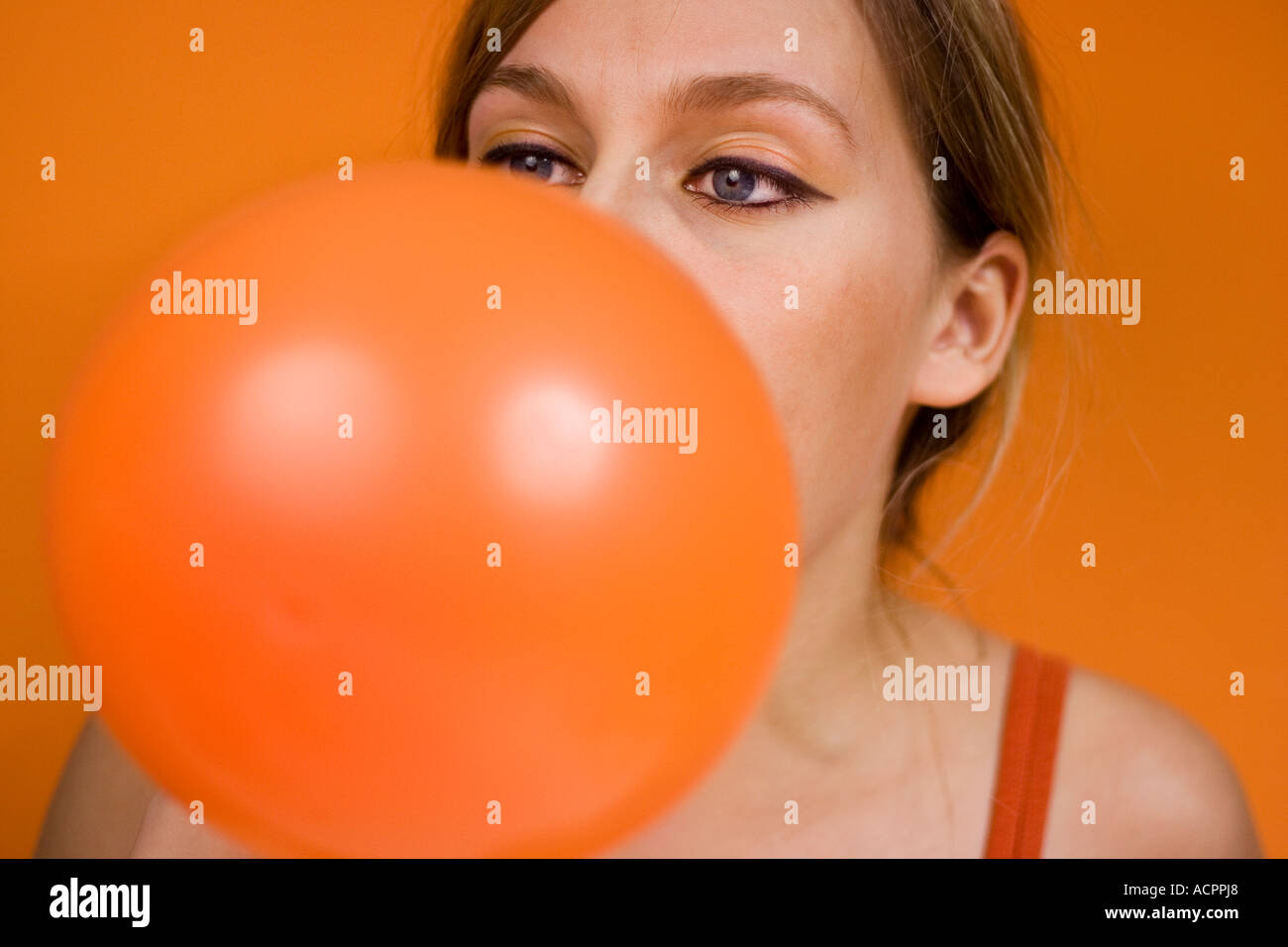 Woman blowing up balloon Stock Photo - Alamy