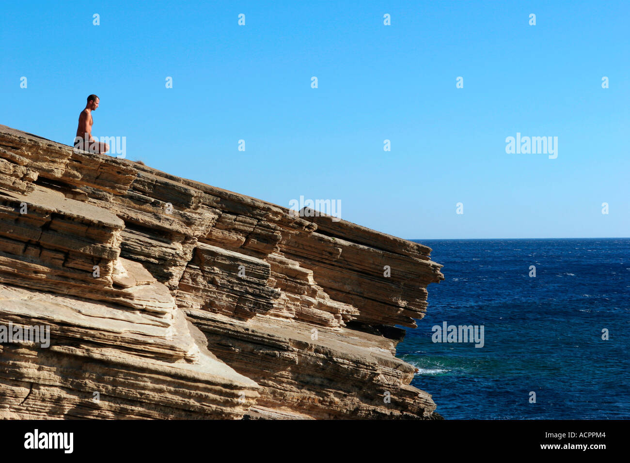 Greece, Crete, man exercising yoga on cliff Stock Photo - Alamy