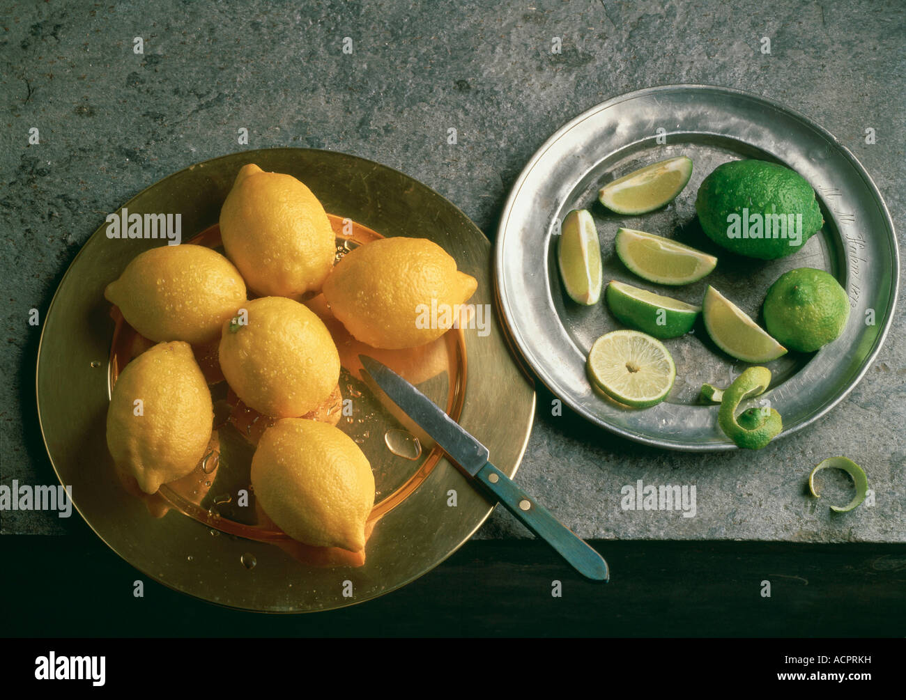 Green and yellow lemons in plates Stock Photo - Alamy