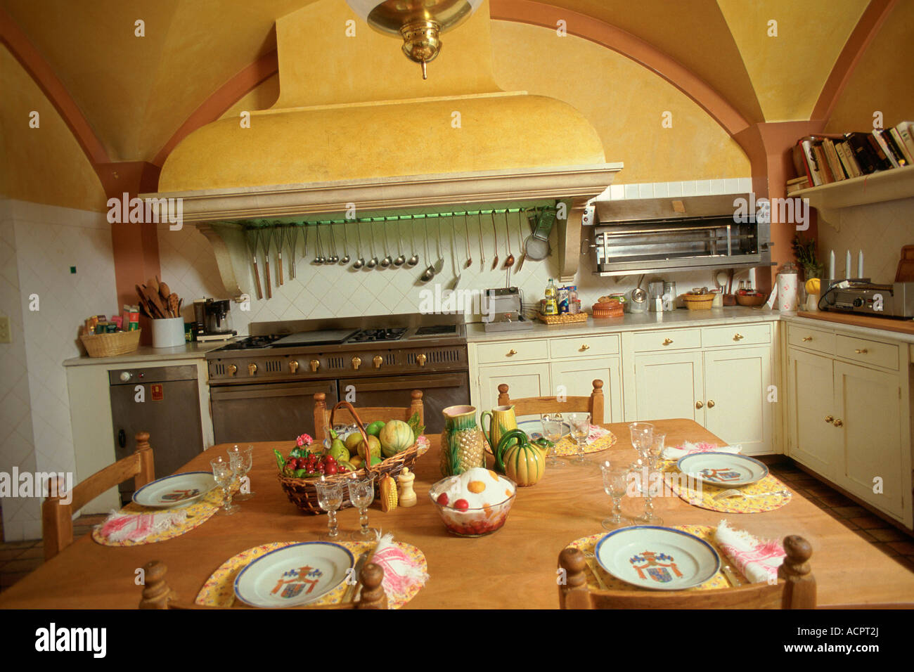 Kitchen table laid embedded kitchen hood Stock Photo - Alamy