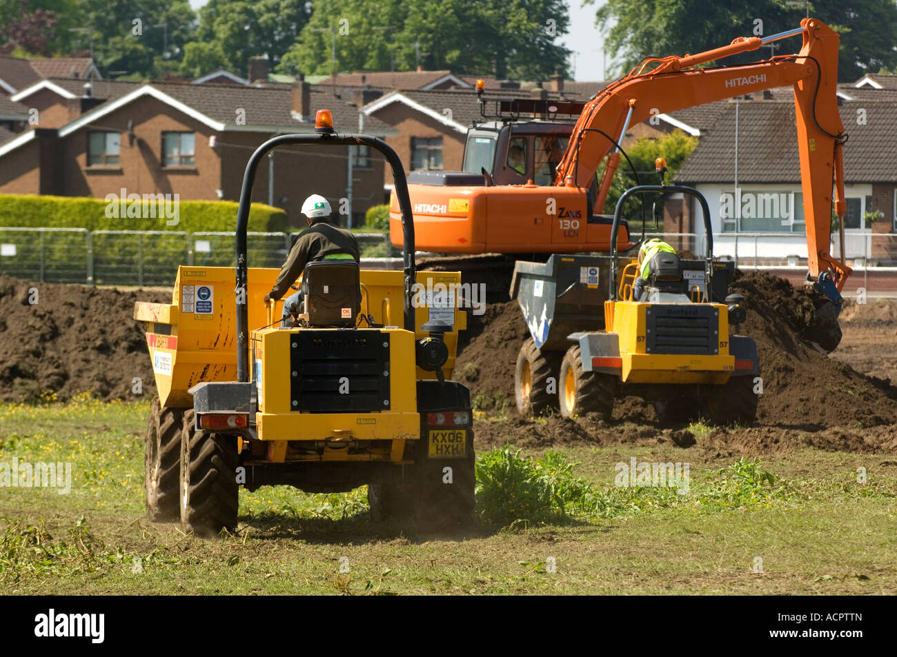 Dump trucks and digger Stock Photo - Alamy