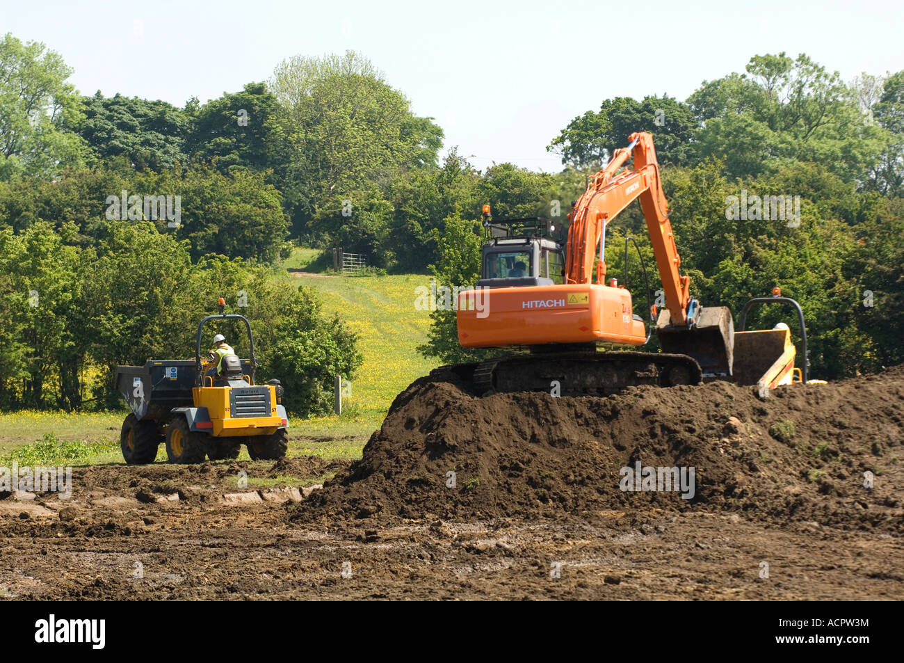 Dump trucks and digger Stock Photo - Alamy