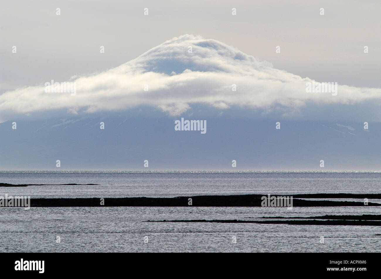 Saint Augustine Volcano in cloud rising above Kamishak Bay in the ...