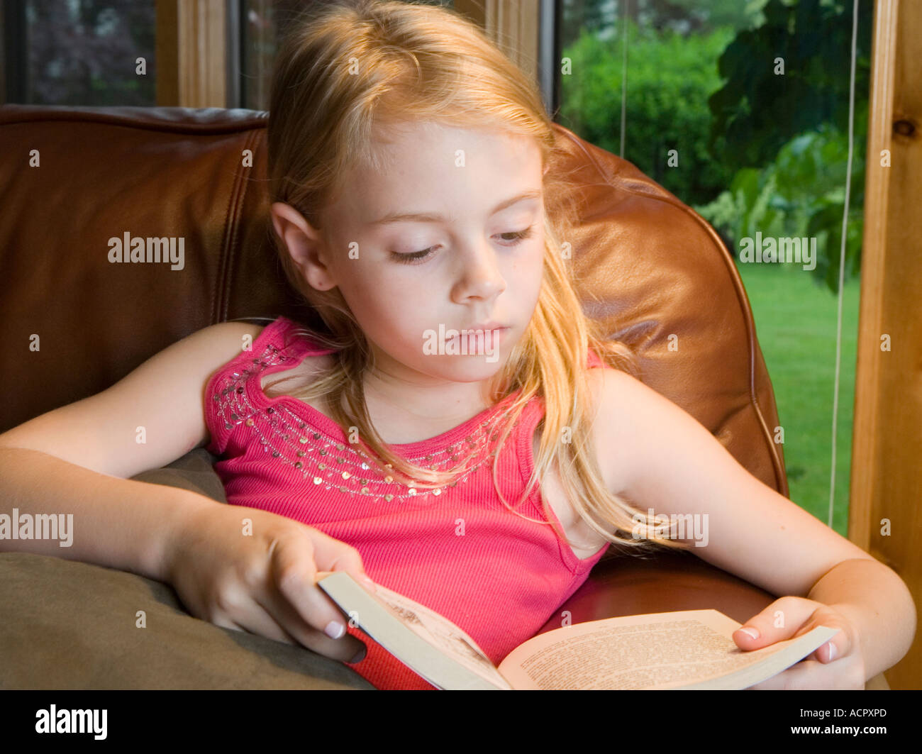 Young girl reading a book Stock Photo - Alamy