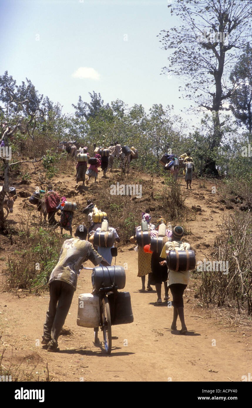 Meru people carrying water away from a water point to their homes in ...