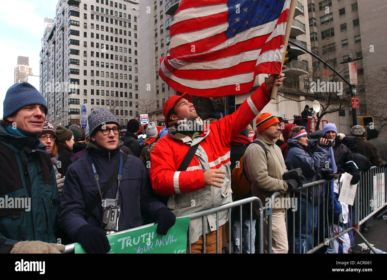 Man holding up American Flag during massive aniti war rally in New York ...