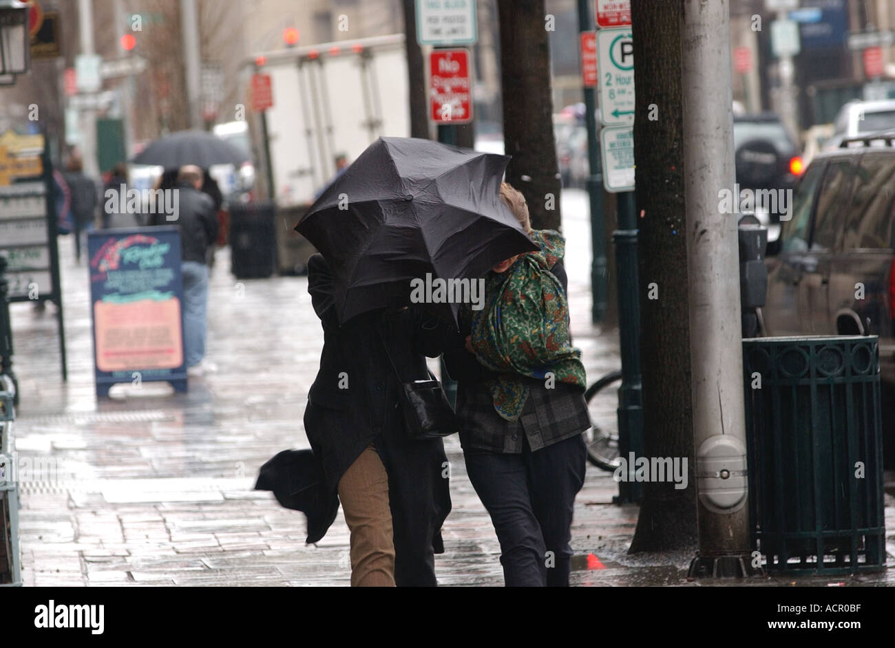 woman caught in wind storm blowing umbrella backwards back Stock Photo ...
