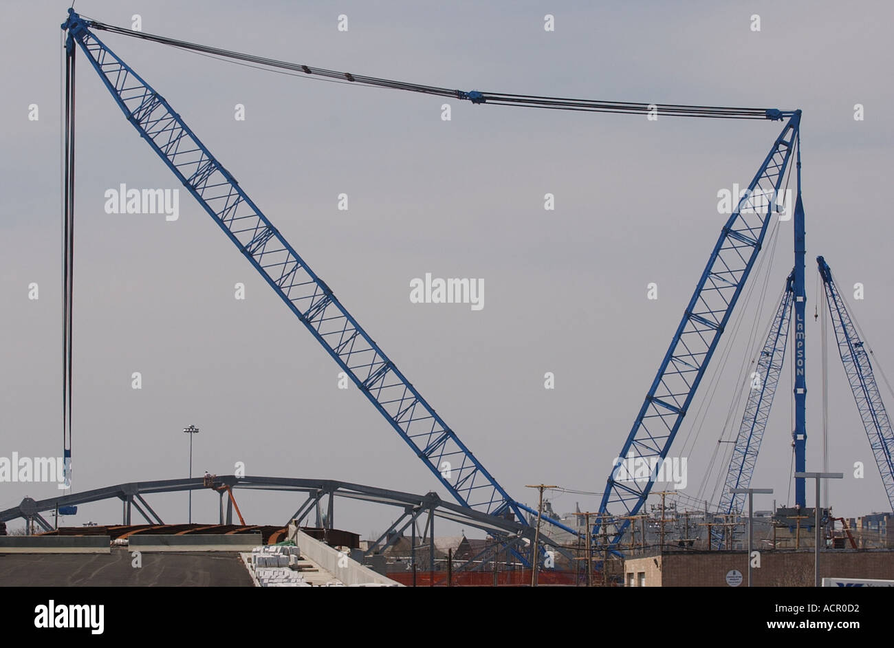 Bridge being lifted into place with massive Crane Stock Photo - Alamy