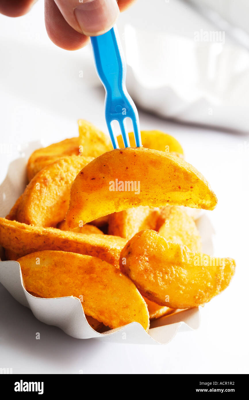 Man skewering potato wedges Stock Photo - Alamy